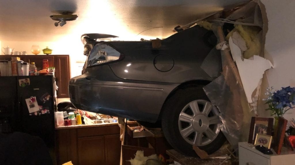 Family returns from funeral to find car in their kitchen